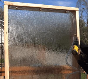 Outdoor Water Wall DIY Using an Old Shower Door - DIY Joy